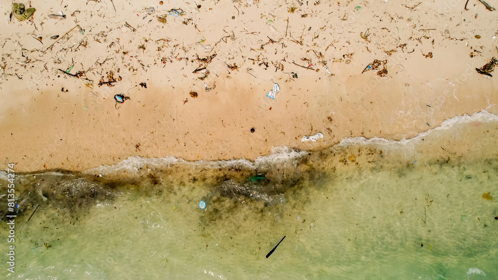 Aerial view of a polluted water body with scattered trash, highlighting ...