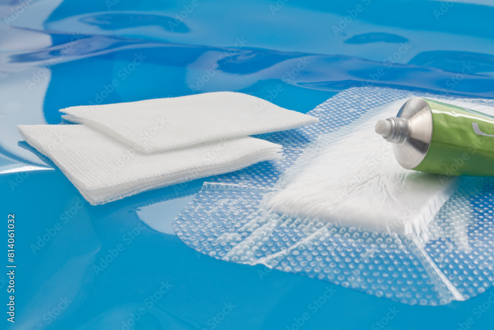 Wound management concept. Two cotton gauze swabs and ointment tube on ...