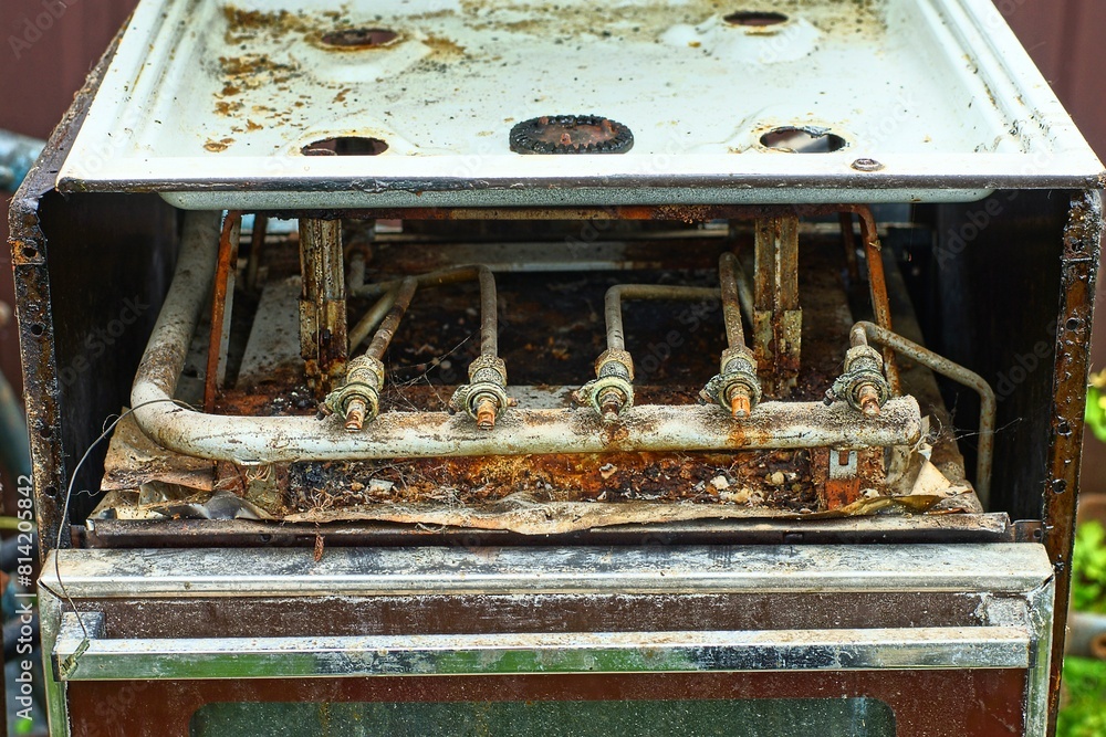 part of a gas industrial kitchen dirty broken discarded without a front ...