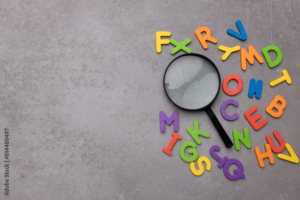Magnifying glass with many wood letters of English alphabets, learning ...
