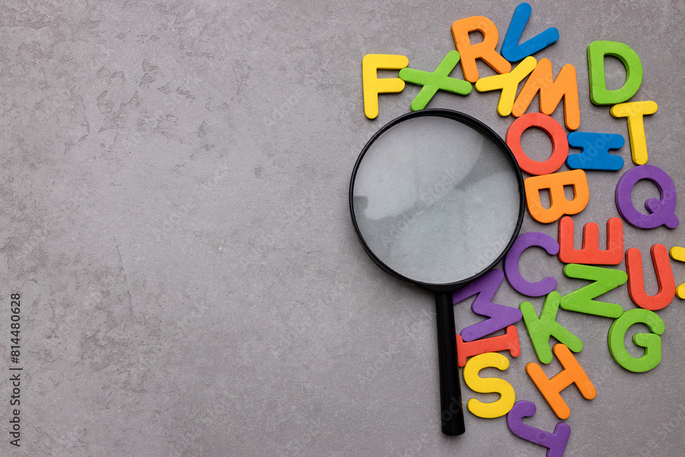 Magnifying glass with many wood letters of English alphabets, learning ...