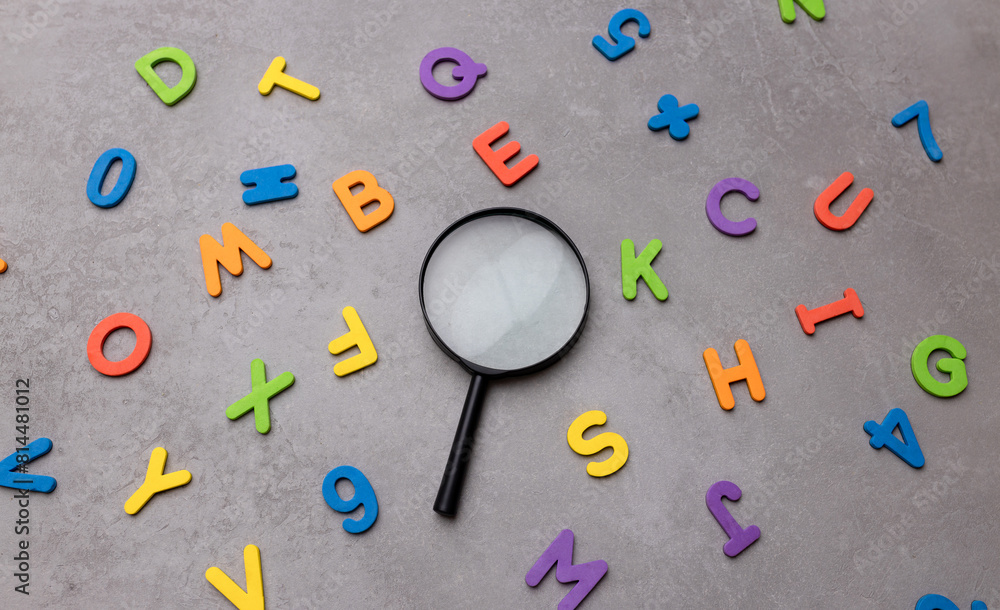 Magnifying glass with many wood letters of English alphabets, learning ...