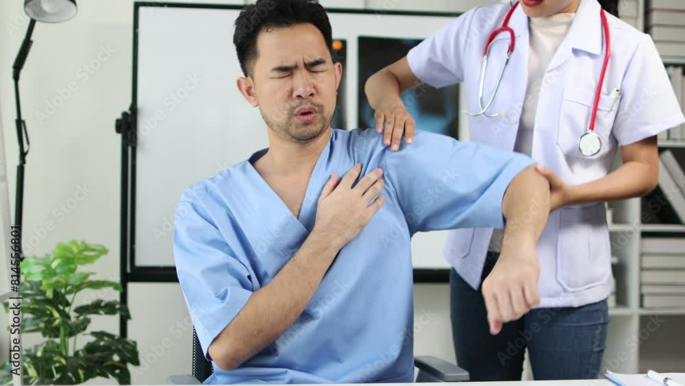 Female doctor is diagnosing pain in a male patient's arm and shoulder ...