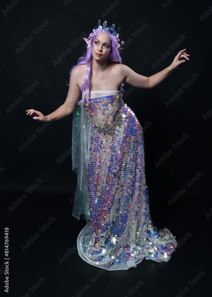 Full length portrait of beautiful female model with long purple hair ...