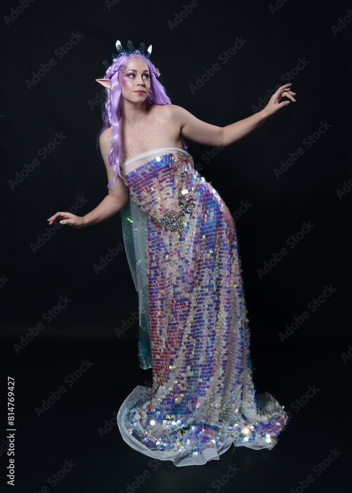 Full length portrait of beautiful female model with long purple hair ...