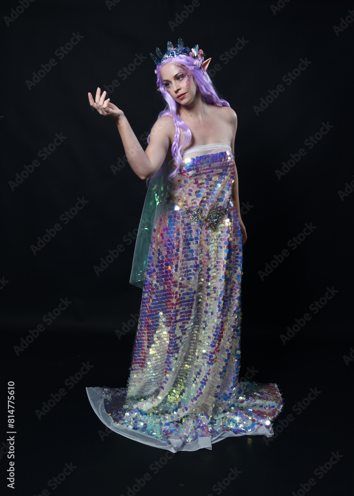 Full length portrait of beautiful female model with long purple hair ...