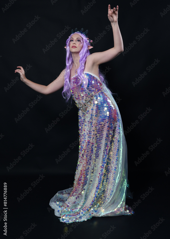 Full length portrait of beautiful female model with long purple hair ...