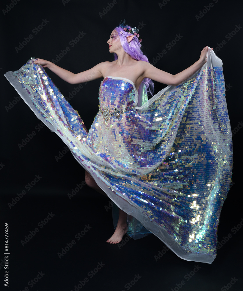 Full length portrait of beautiful female model with long purple hair ...