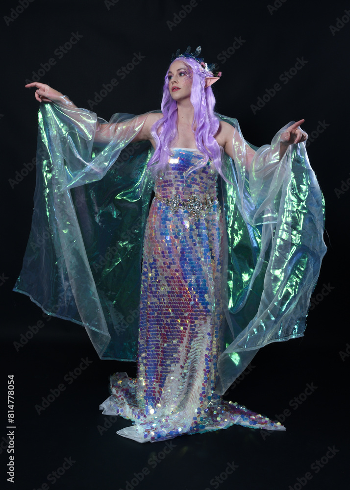 Full length portrait of beautiful female model with long purple hair ...