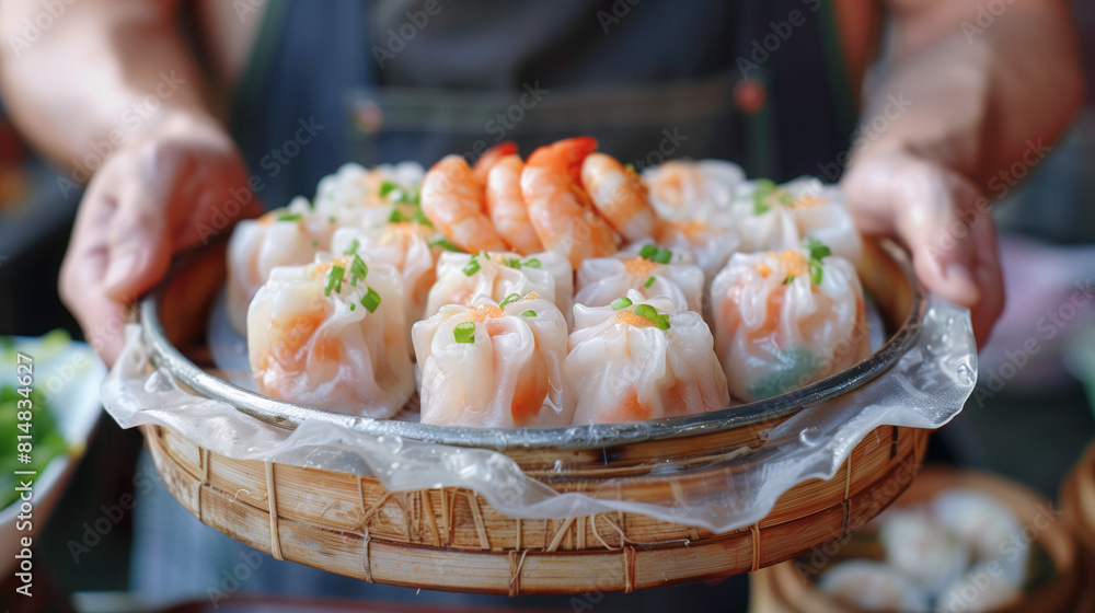 Chinese man presenting a plate of mouth-watering steamed shrimp ...