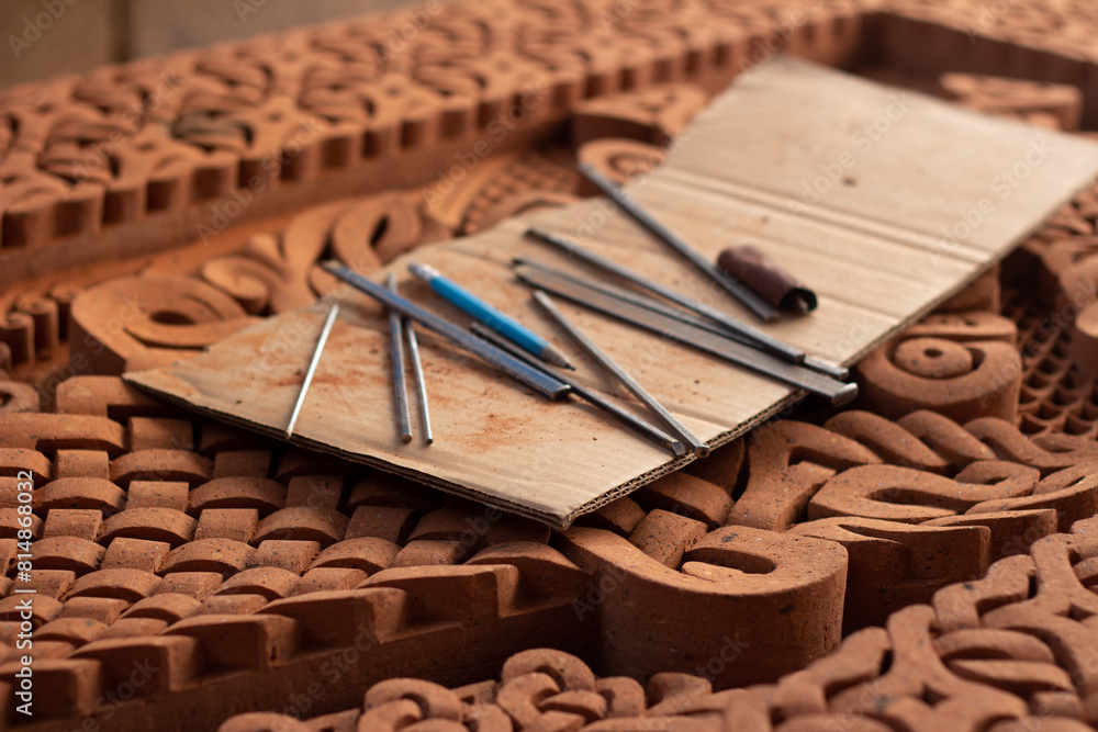 Yerevan, Armenia. Set of work tools, gravers, chisels lies on red brick ...