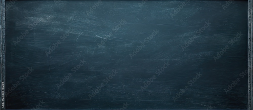 A dark blue chalkboard with traces of erasing featuring a full surface ...