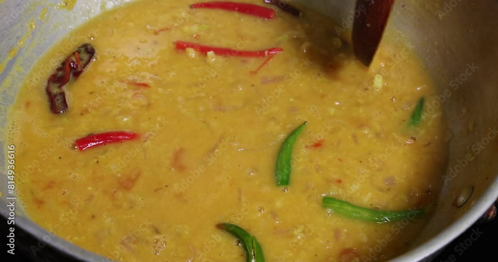 Adding boiling dal lentil into bagar tadka with deep fry tomato onion ...