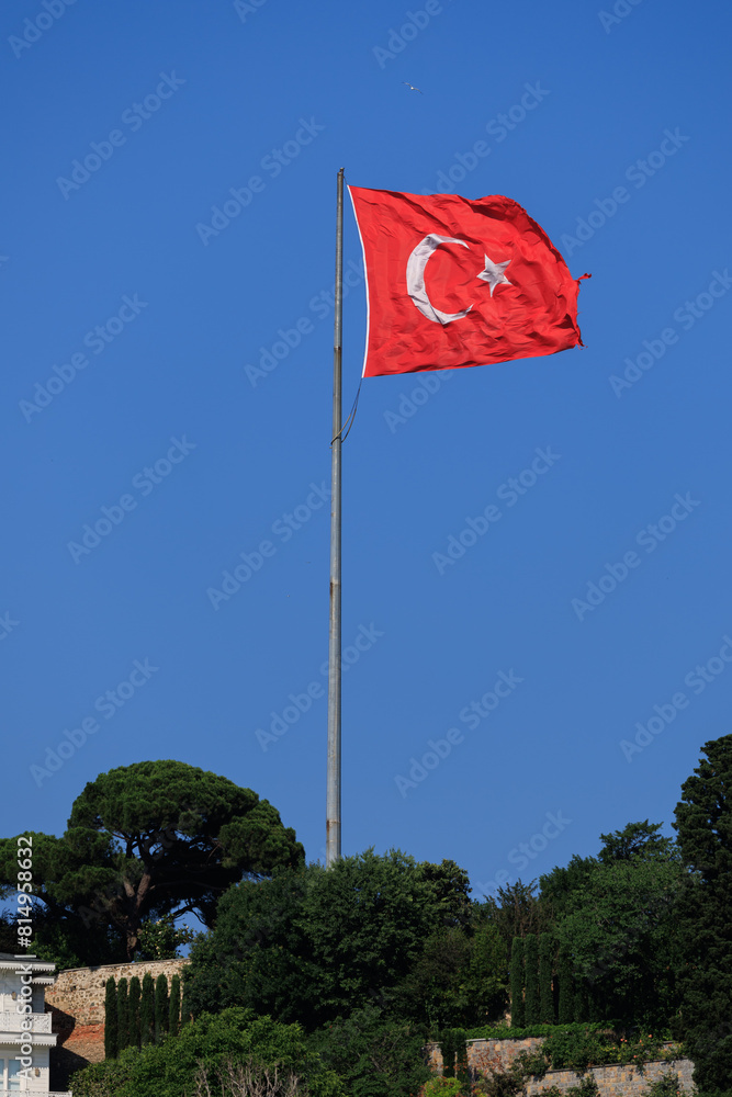 Turkish flag, on a red background white star and moon. Flag flies in ...