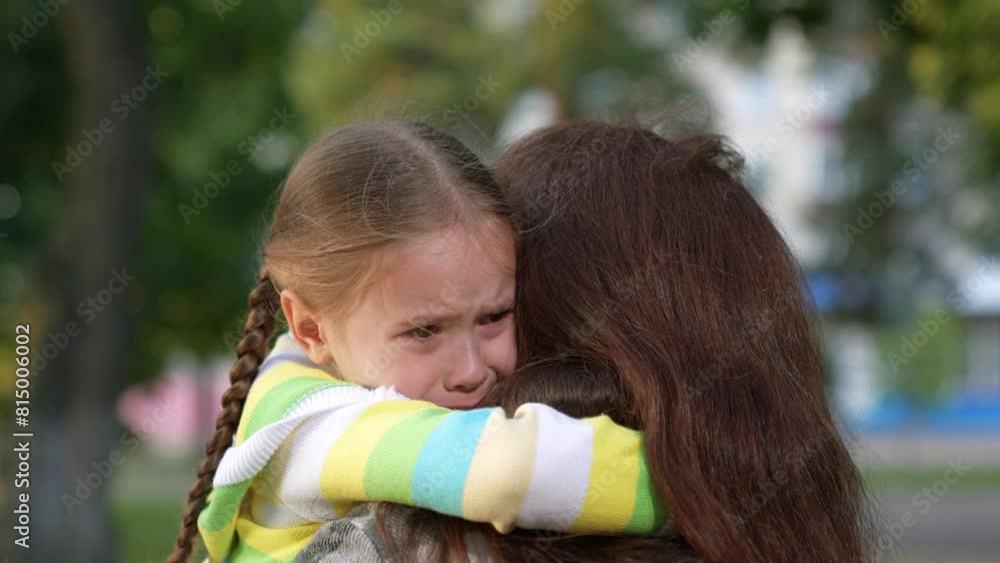 little child cries, tears child face, mother calms capricious kid girl ...