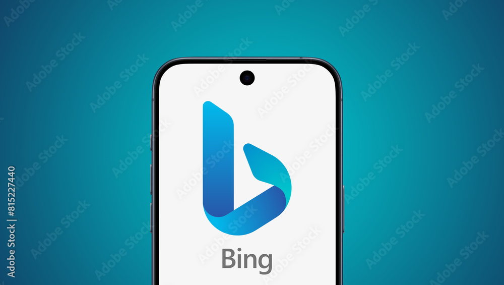 Bing logo is displayed on a modern smartphone with in front of a blue ...