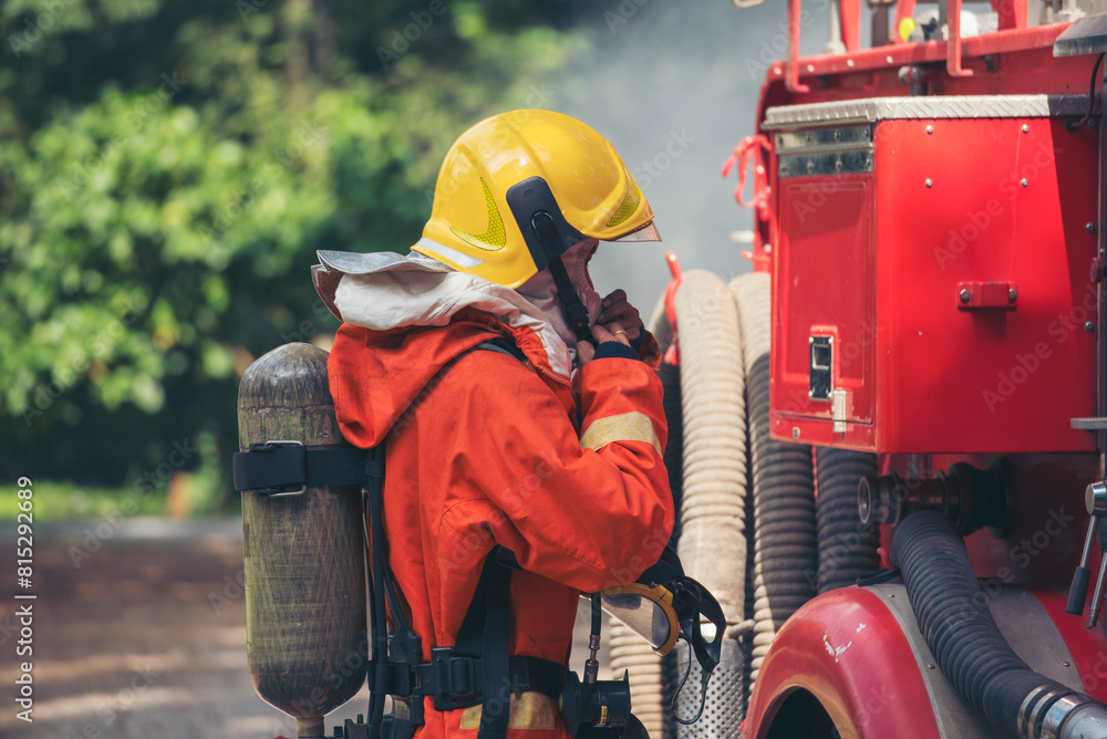 Fireman prepare equipment fighting extinguisher at fire engine truck ...