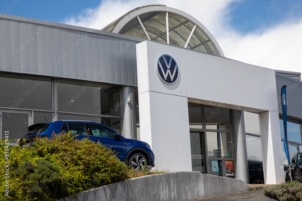 vw logo brand facade and sign text shop front of dealership store ...
