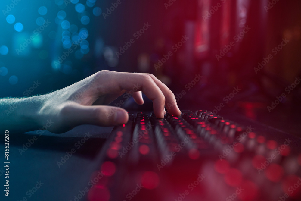 Hands, neon and typing on gaming keyboard computer in home for esports ...