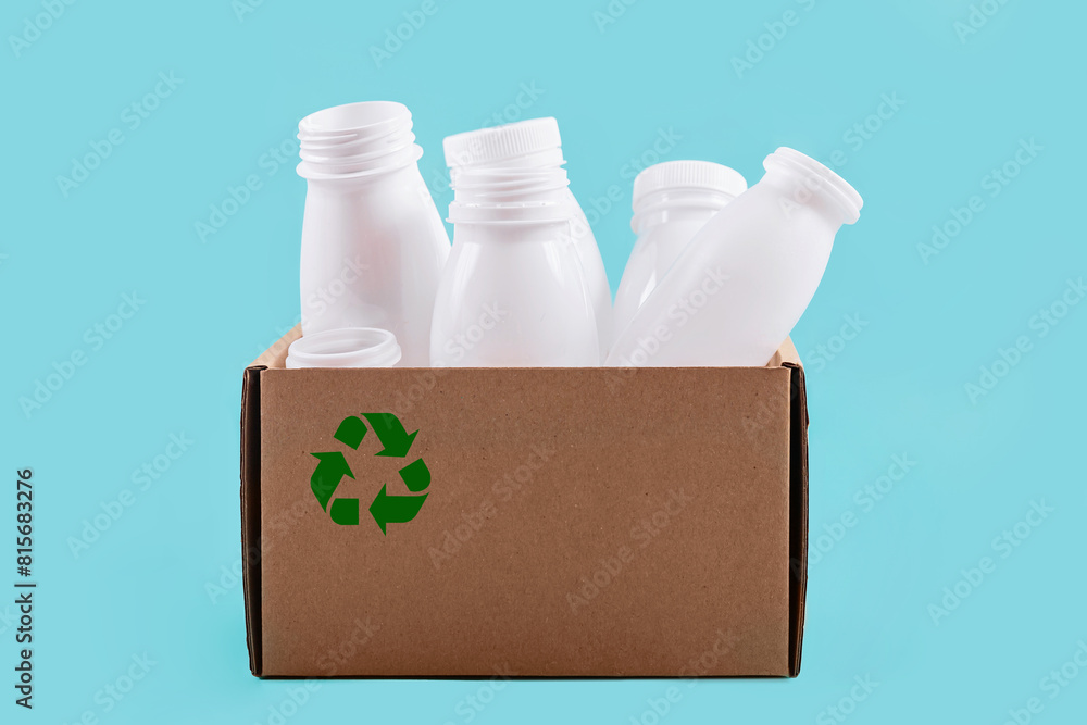 White plastic bottles organized within a cardboard container ...