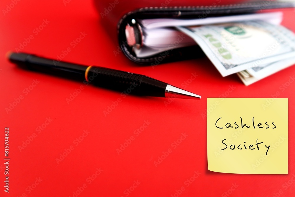 Yellow note on red copy space, pen notebook and cash background with ...