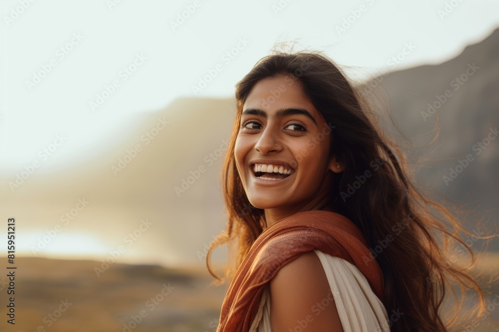 portrait of a beautiful indian woman outside, glancing over her ...