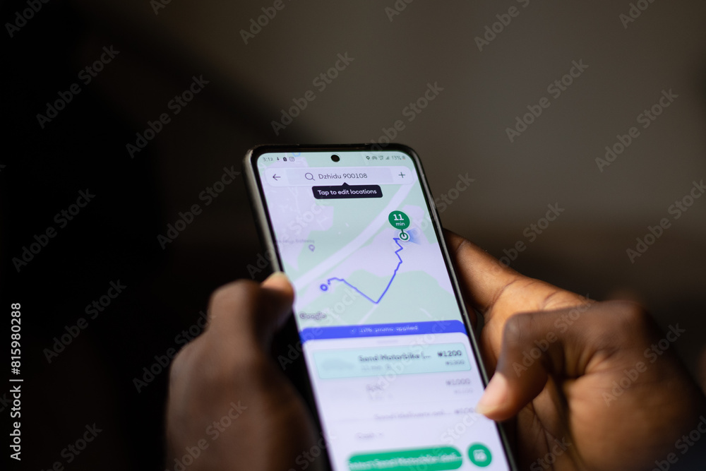 Lugbe, Abuja-Nigeria - April 22nd 2024: african person using bolt ride ...