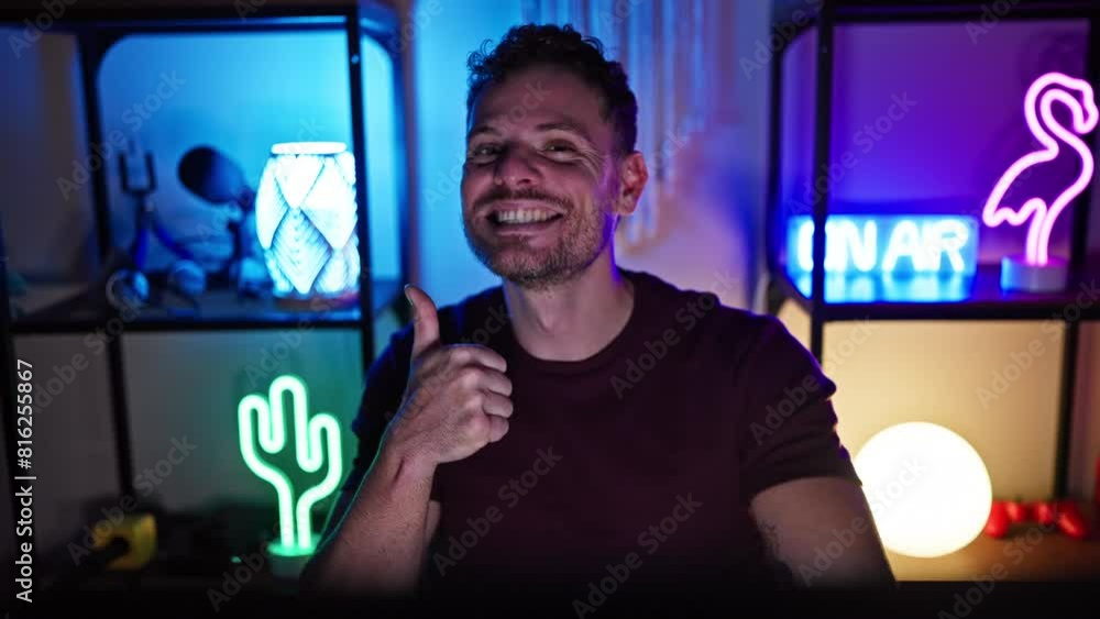 Cheerful young man is acing his video game, thumbs-up gesture in ...