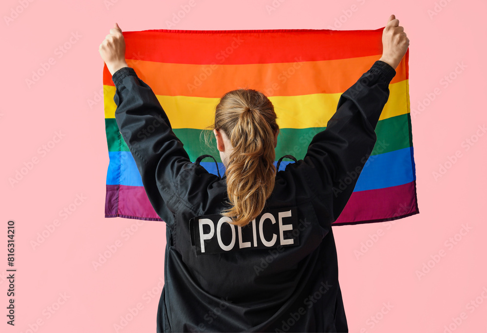 Female police officer with LGBT flag on pink background, back view ...