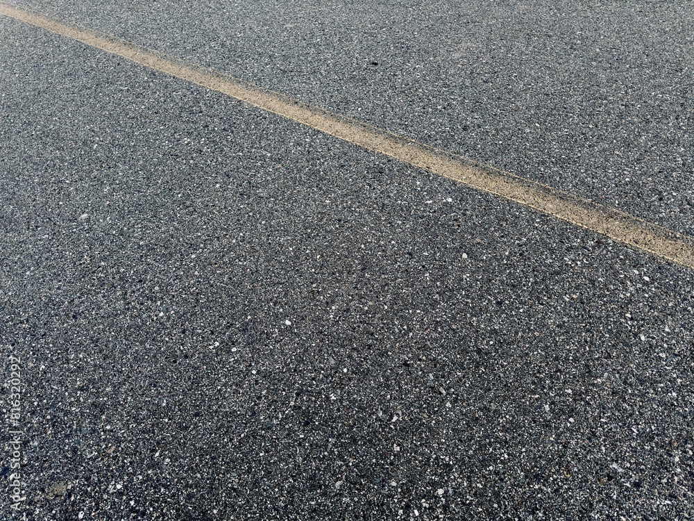 A rugged video of a wild asphalt road surface, marked by cracks and ...