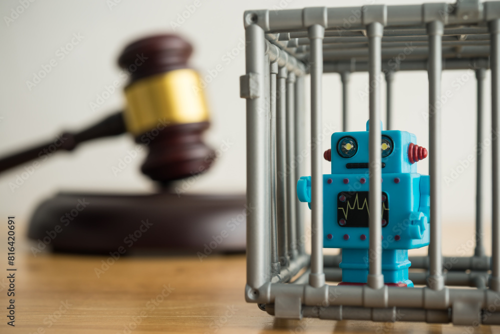 AI artificial intelligence bot in jail and hammer judge gavel on wooden ...
