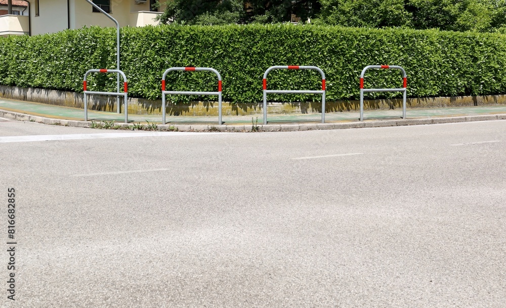 Metallic pedestrian barriers with red visibility strips, at the corner ...