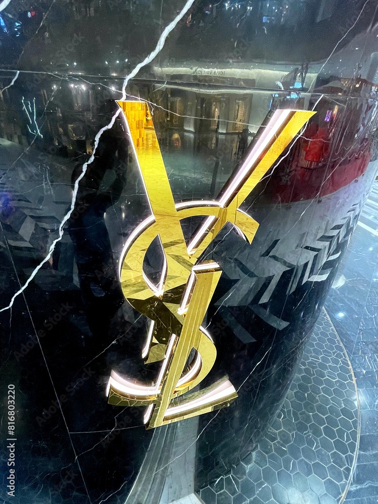 Yves Saint Laurent fashion house logo on the wall. Sign of YSL close-up ...