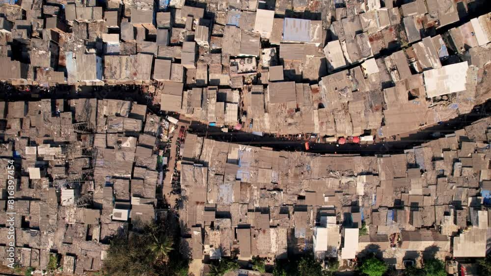 Top aerial view of Dharavi slums next to busy road in Mumbai ...