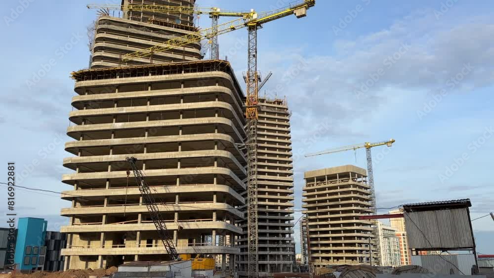 Construction site with buildings under construction. Tower cranes in ...