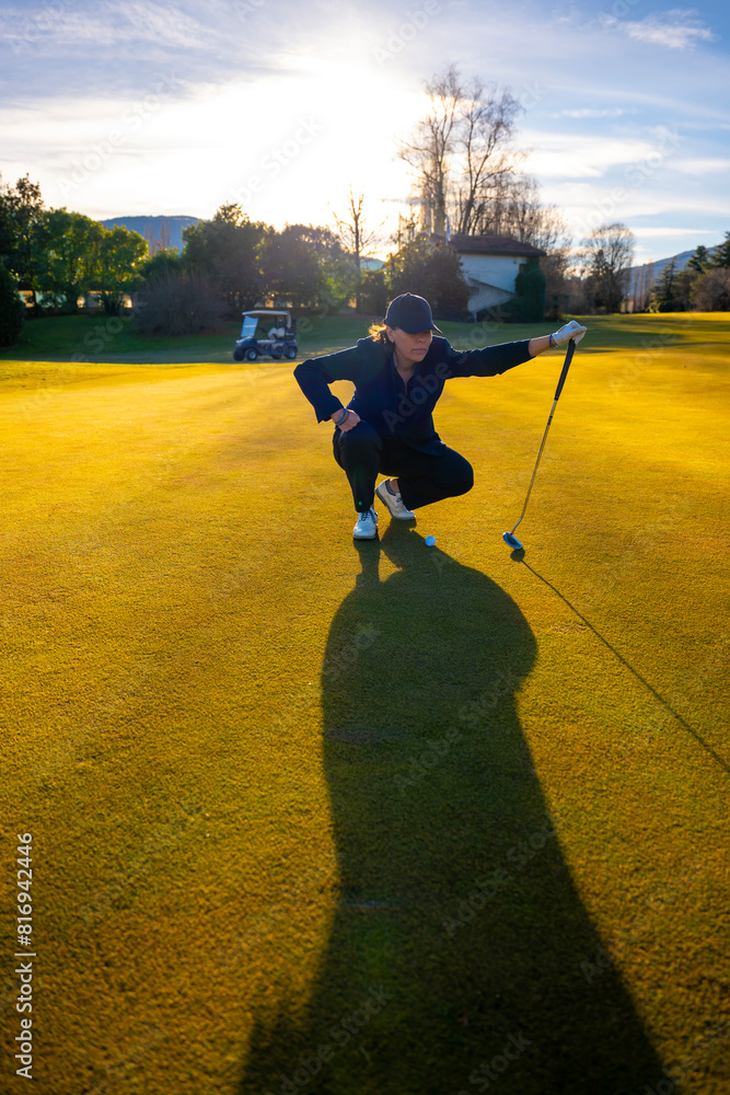 Female Golfer with Shadow on the Putting Green in Sunset with Lens ...
