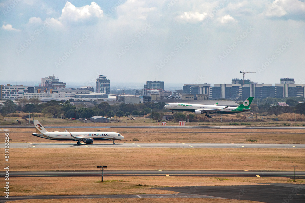 Eva Air Airbus A330 landing and a Starlux Airbus A321 taxing to runway ...