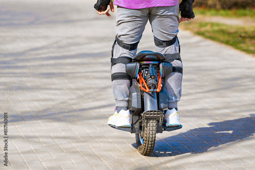 Man in safety gear riding EUC electric wheel closeup. Man commuting on ...