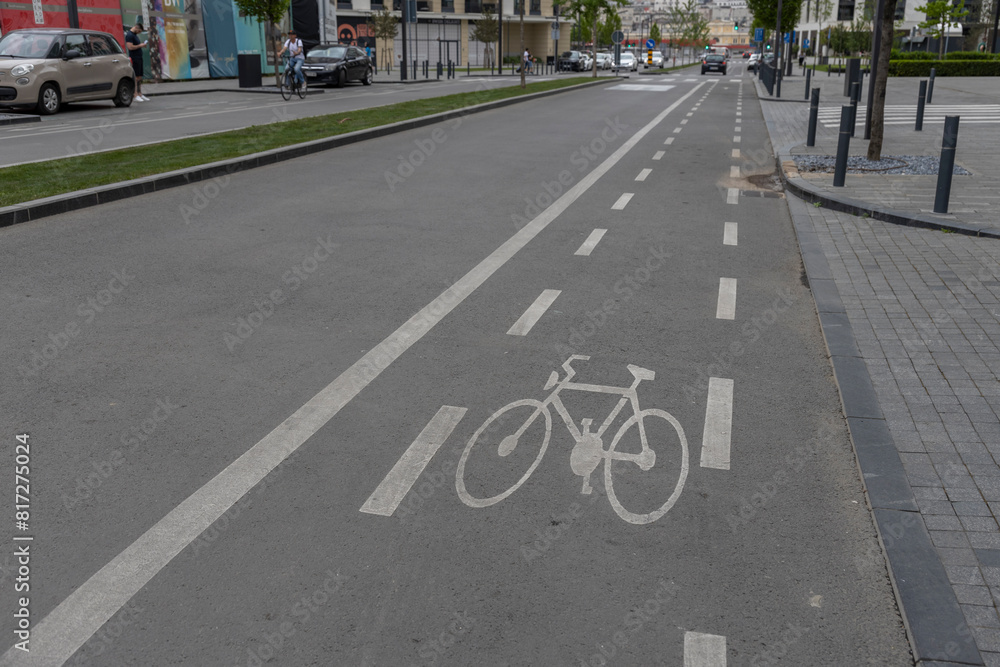 A well-marked bike lane on an urban road with clear road markings, a ...