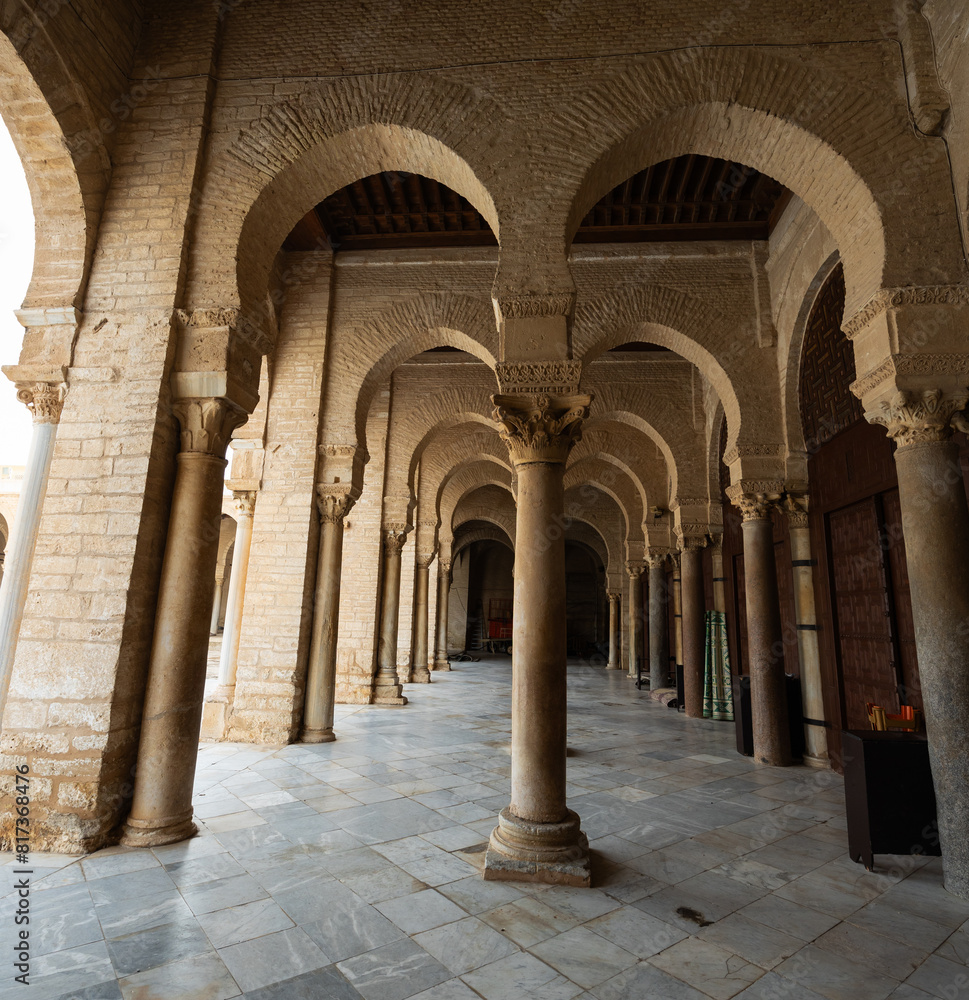 Long corridors under vaulted ceiling in ancient mosque of Kairouan in ...