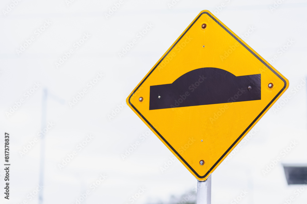 Mobility sign indicating caution with speed bump on the road, traffic ...