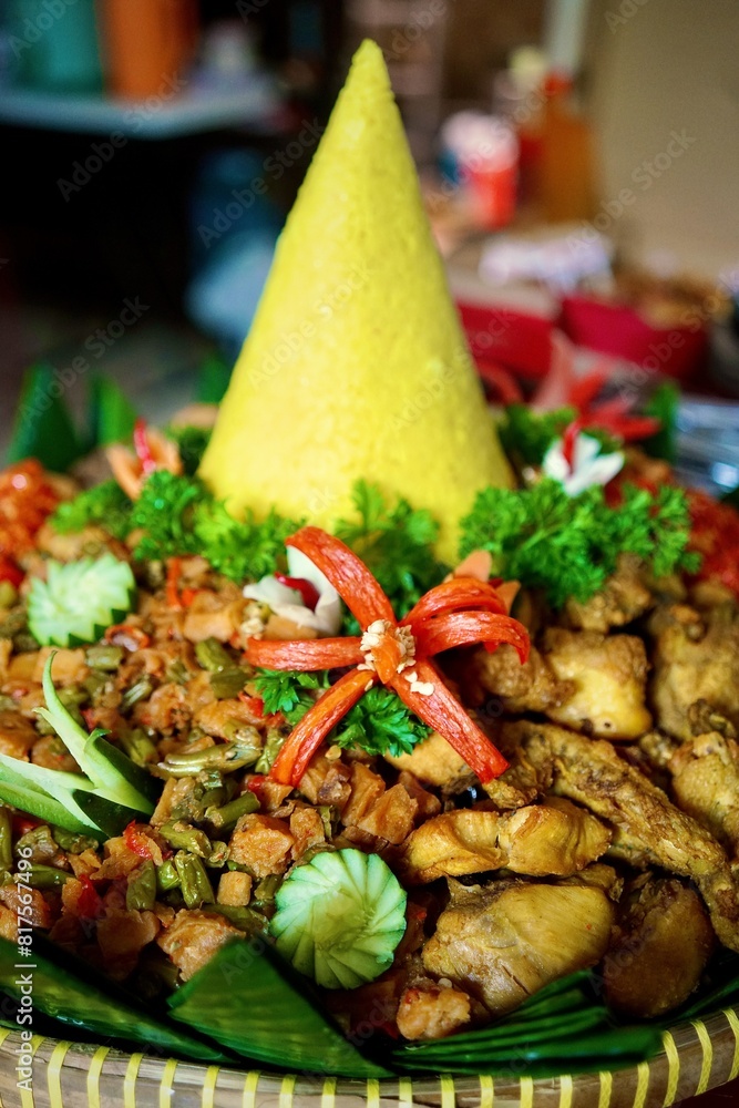 Wide view of Nasi Kuning (Indonesian yellow rice with aromatic spices ...