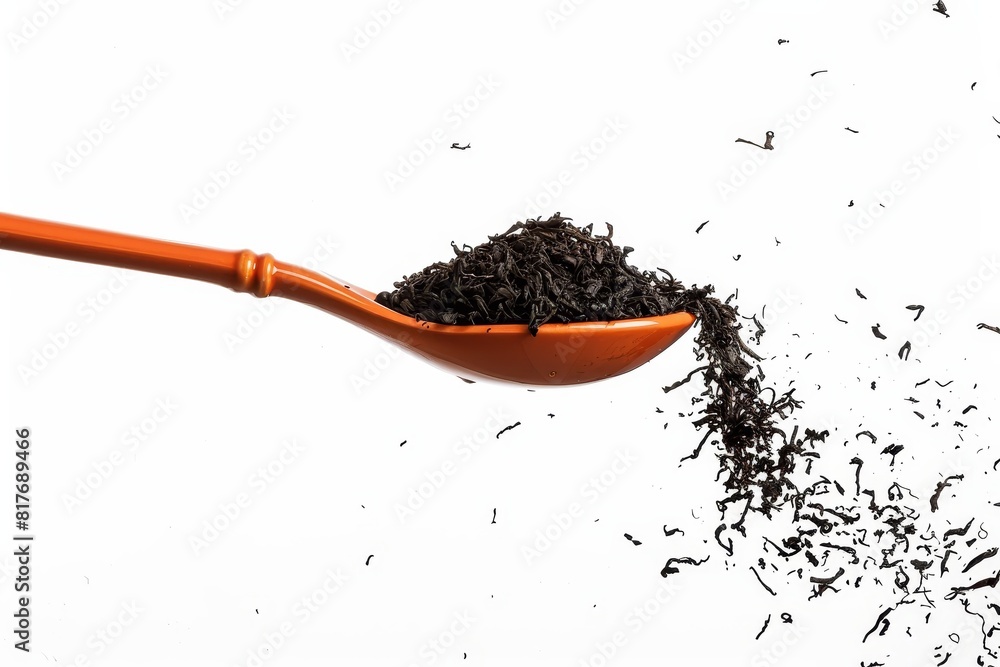 Black tea dripping from orange spoon on white background Stock Photo ...