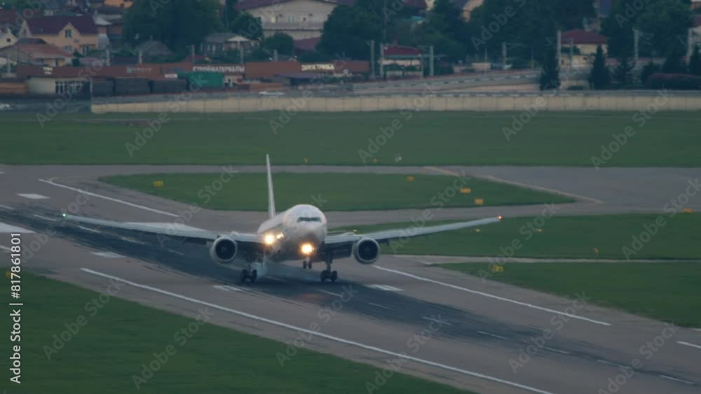 Jet passenger plane is landing and touching, braking, spoilers up ...