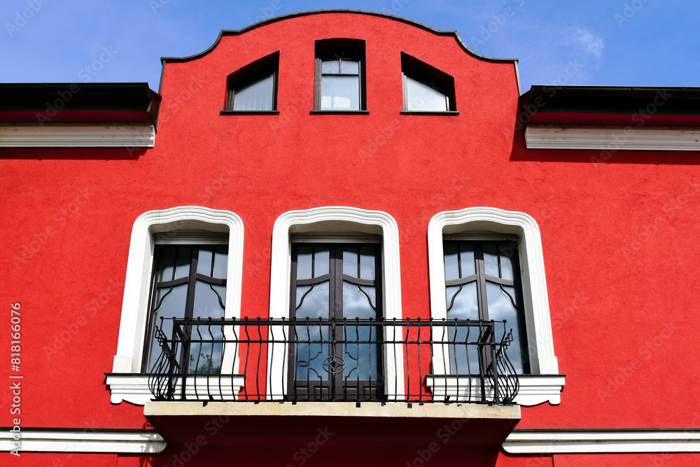 red stucco building elevation detail with wrought iron balustrade and ...