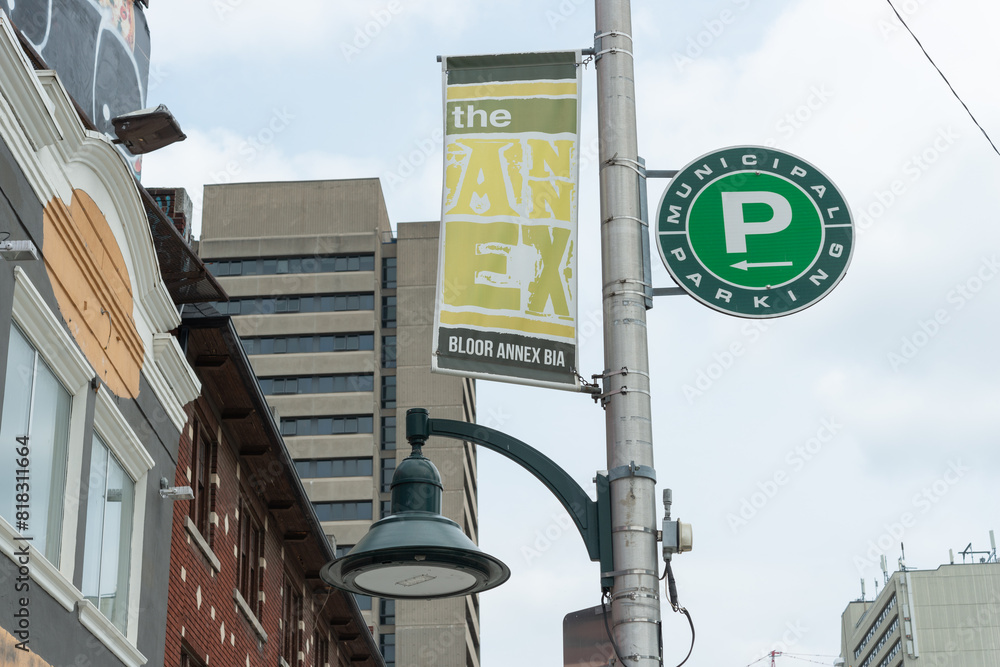 City of Toronto Municipal Parking sign and BIA banner for The Annex, a ...