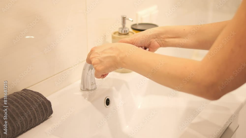 Video „Woman washes face in bathroom water gently splashing Water flows ...