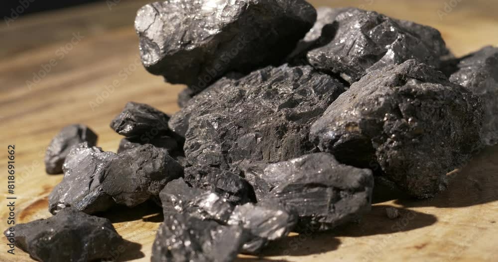 Background from pieces of black coal on a wooden slab. Fossil fuel ...