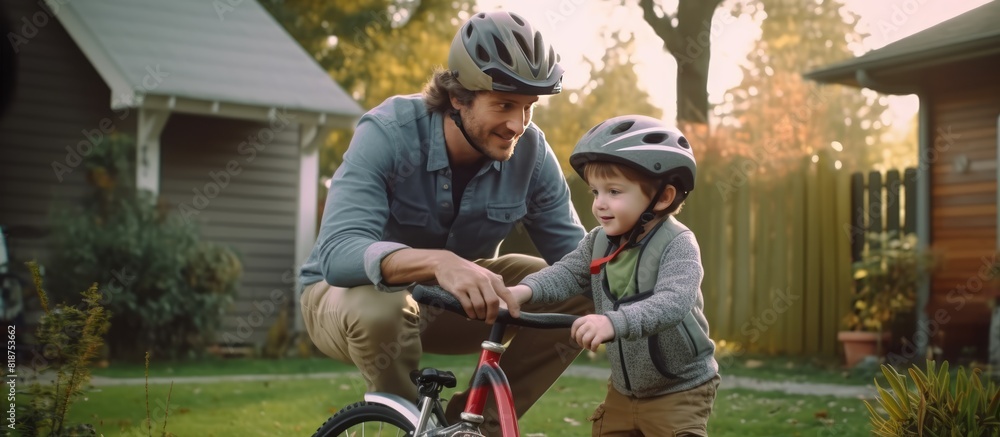 portrait of an active father helping teach his young son to learn to ...