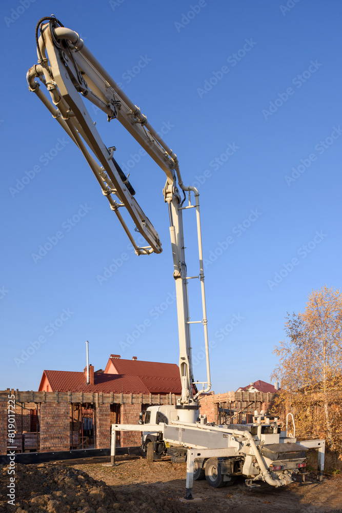 White truck mounted concrete pump with decomposed boom with hydraulic ...